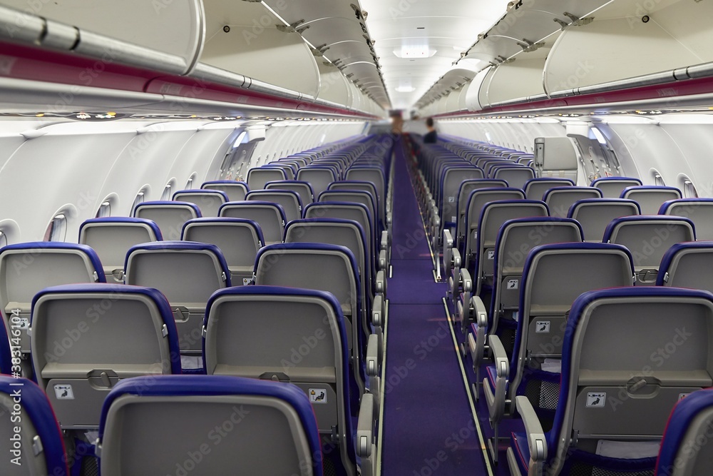 Airplane cabin interrior with empty seats, almost nobody onboard Stock ...