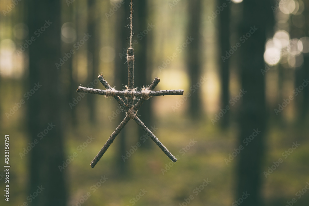 Witchcraft sticks symbol. Magic occult symbol. Totem hanging on tree in ...
