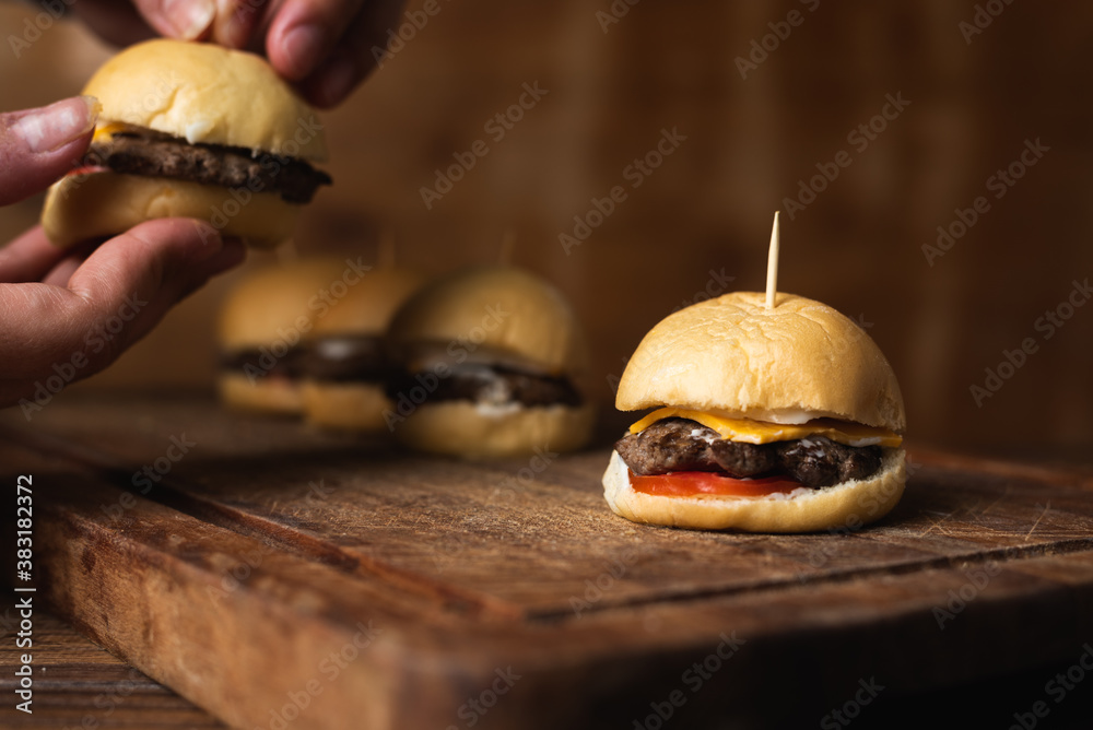 Delicious homemade mini burger with ground beef, cheddar cheese, tomato ...