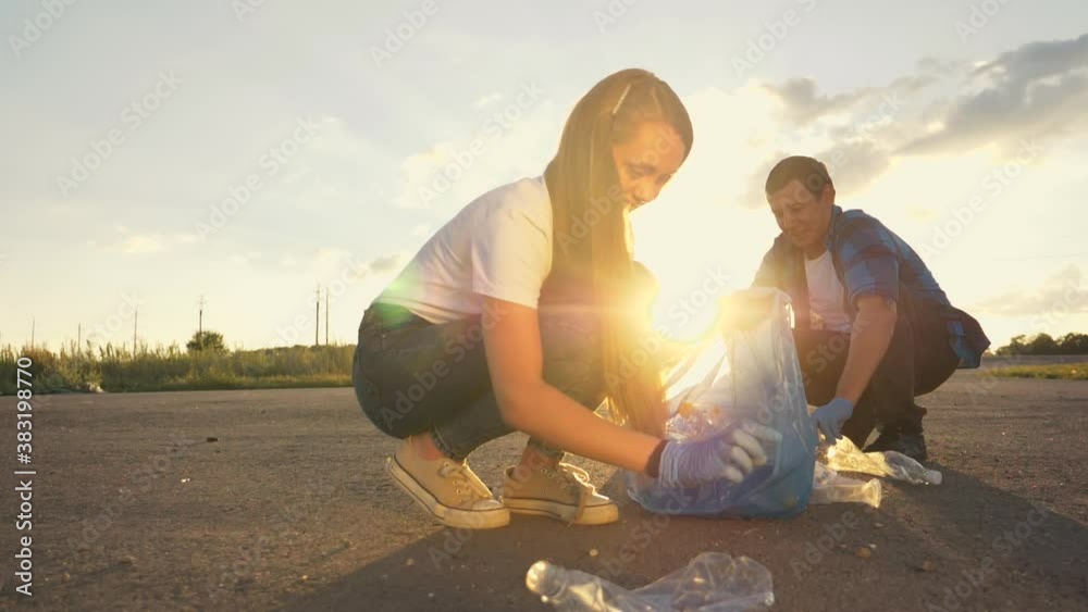 Volunteers father and daughters take away plastic waste. Happy family ...