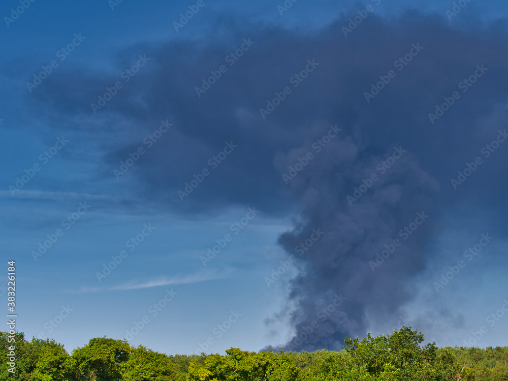 A Burning plastic recycling place causes a big pile of dark, black ...
