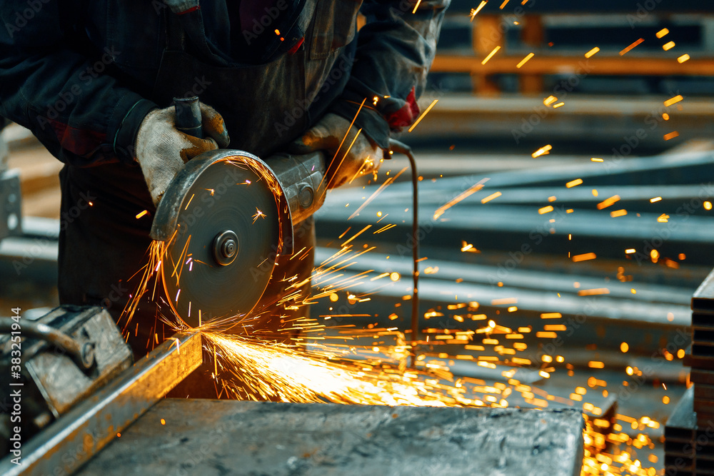 Cutting a metal beam using an electric hand saw. Stock-Foto | Adobe Stock