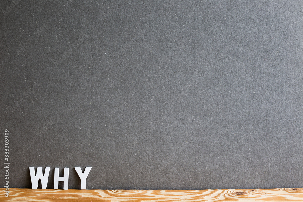 Why question word on wooden table with gray background. Thinking ...