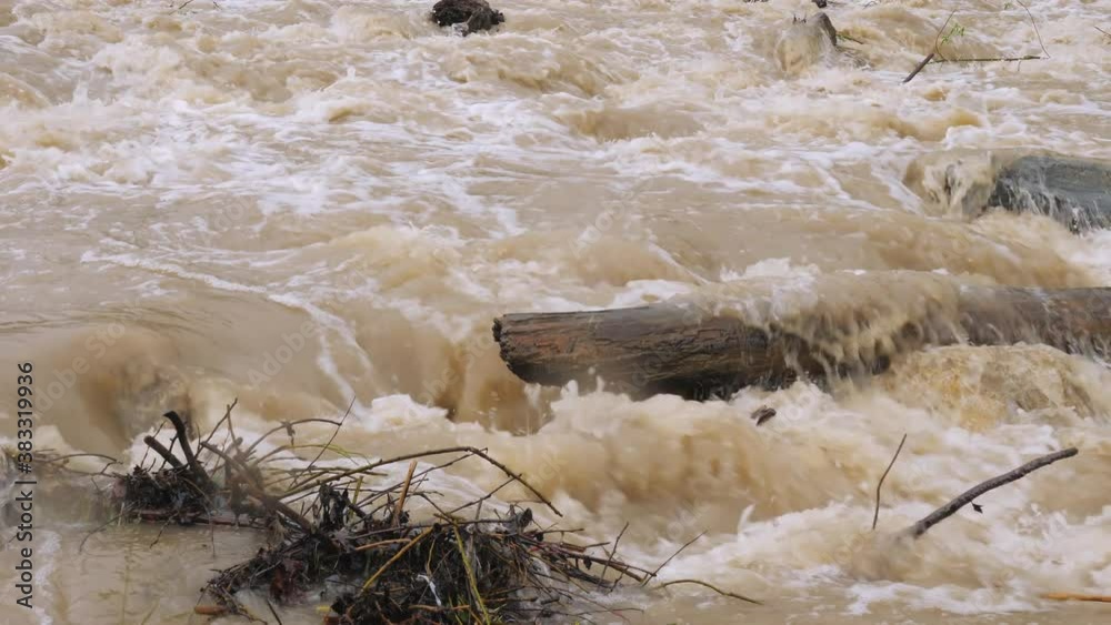 Raging river with dirty water. Crowded river overflows its banks ...