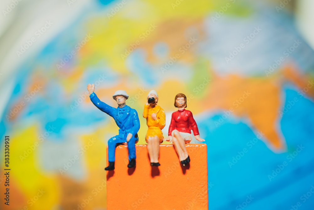 Miniature people, man and woman sitting on world map background using ...