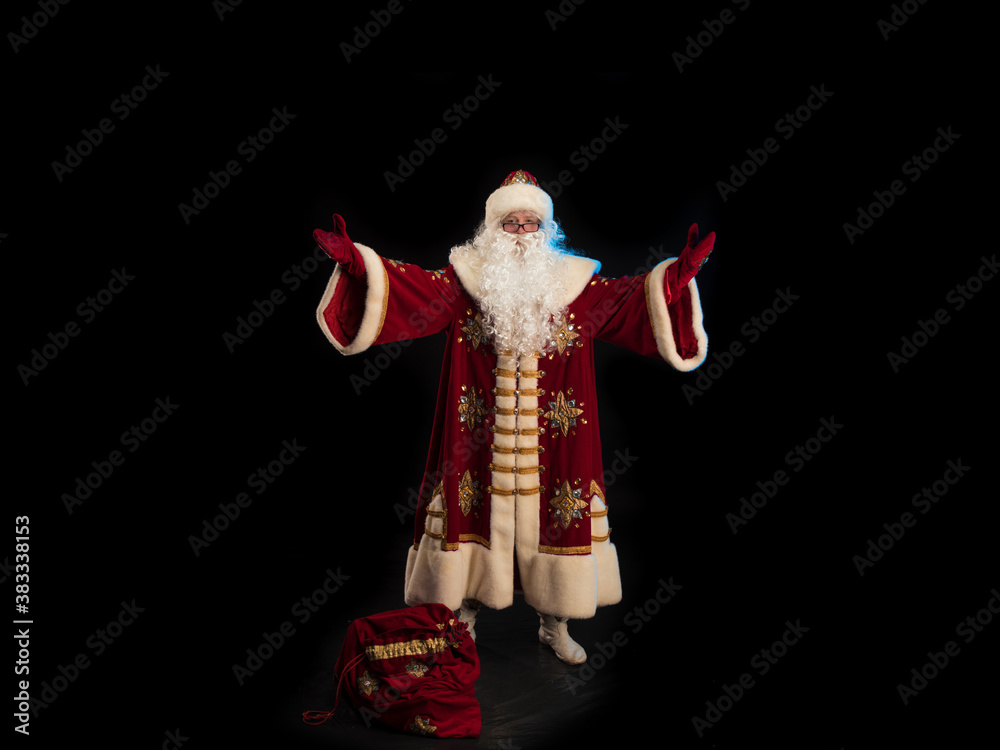 Santa Claus in a red fur coat, with a white beard and a bag of gifts ...