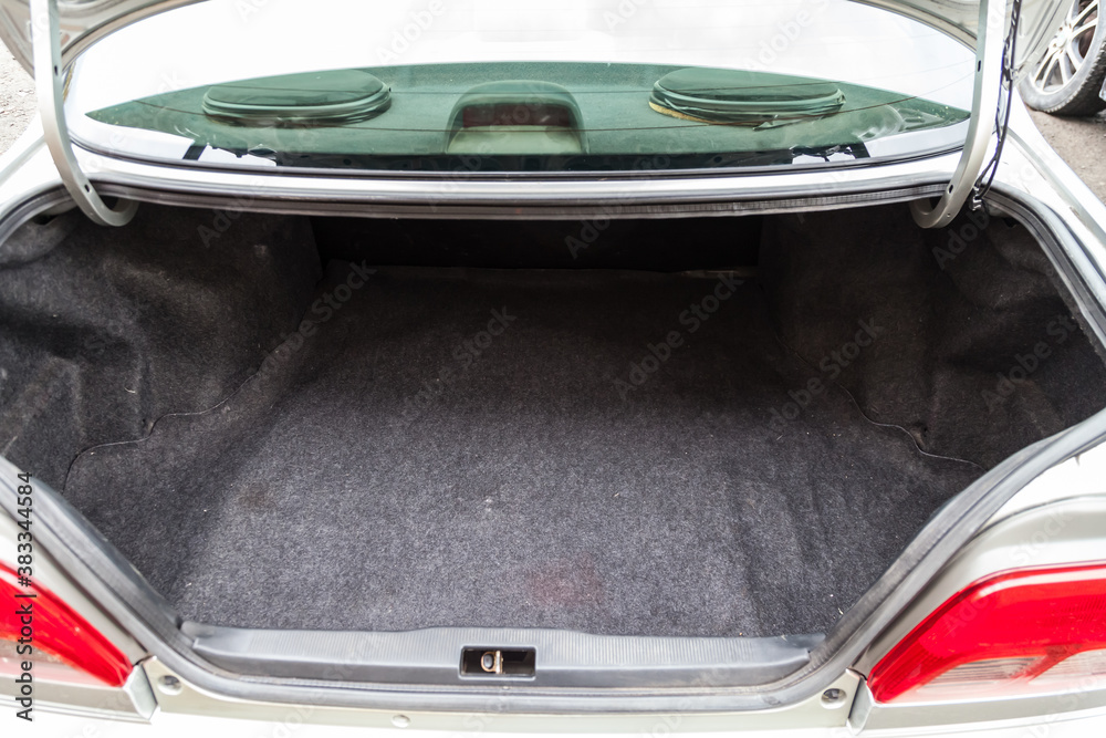Open empty trunk of a car sedan close-up after washing and vacuuming ...