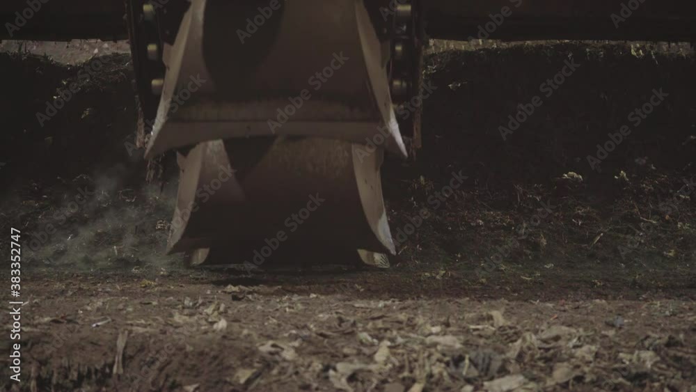 Big moving bucket wheel collects organic waste from a garbage heap ...