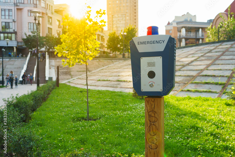Panic alarm, police, emergency button in the public park. Blue box with ...