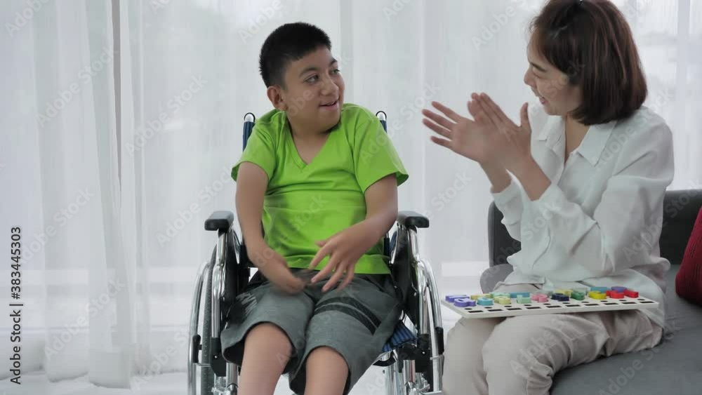 Happy Asian family Mother and son with disability in a wheelchair ...