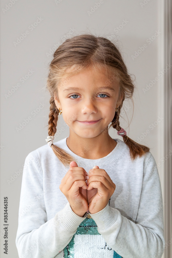 Portrait of cute little girl showing hand heart gesture, sweet precious ...