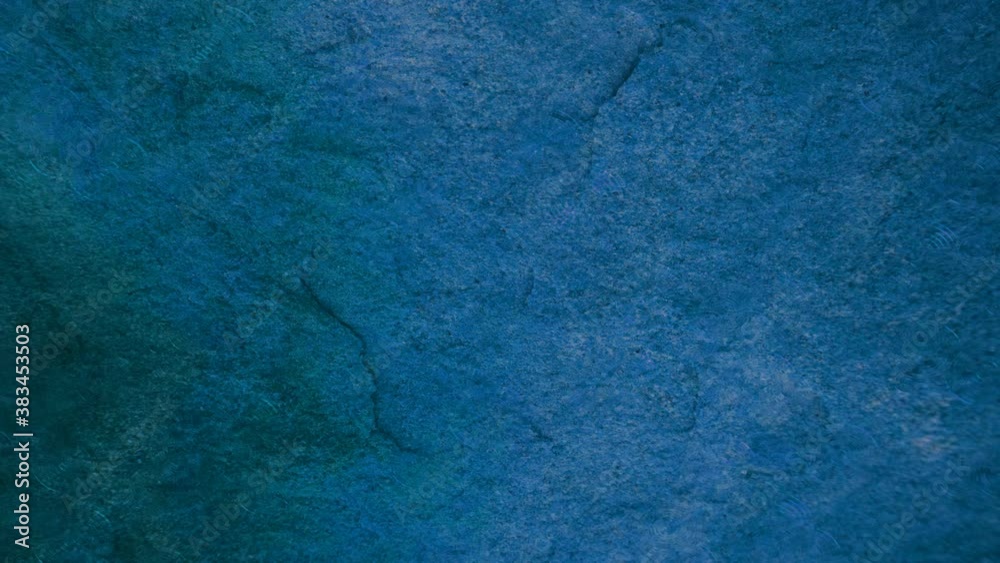 4K rain drop on heavy hard granite dark blue stone surface of cave for ...