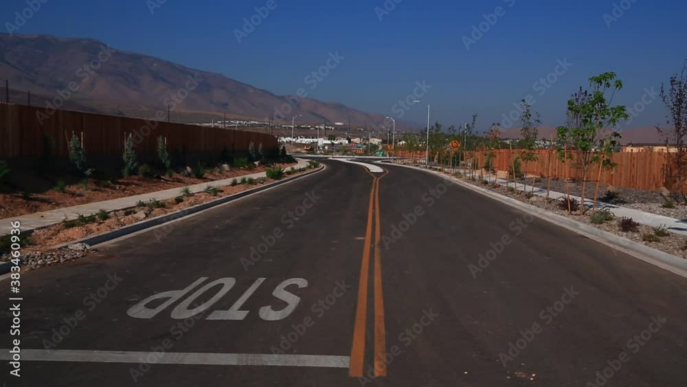 Tilt up intersection in road by stop sign double yellow lines headed ...