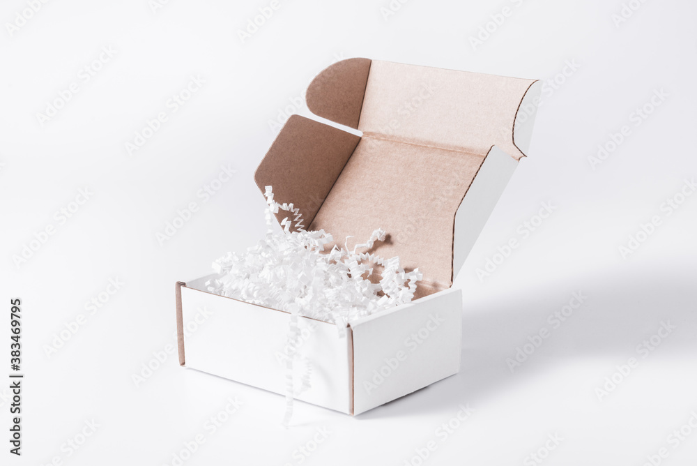 White cardboard, carton flat box with paper filler on background Stock ...