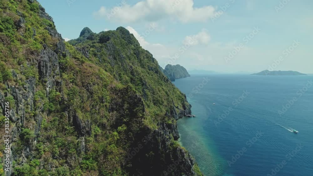 Mountain island with green tropical forest at cliff ocean shore ...