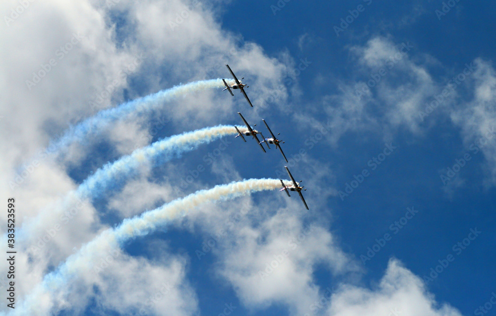 An attractive aircraft show at the airport show. Four airplanes flying ...