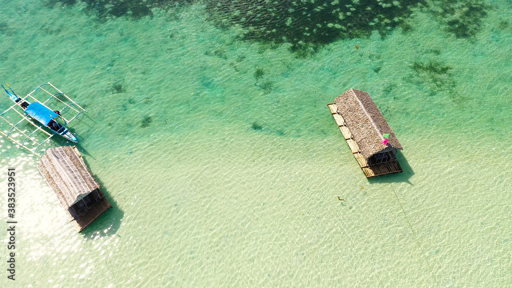A floating native cottage on a sandbar in the tourist island of ...