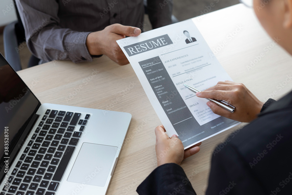 Male job applicants are submitting a resume to the head of the HR ...