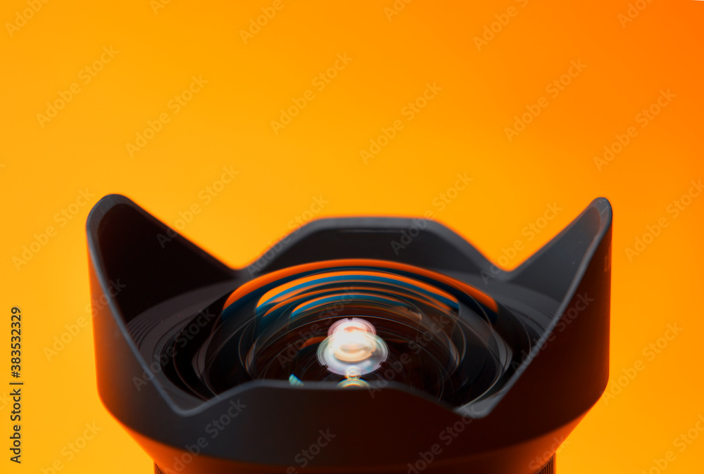 Bright light. Flare reflection in photo, camera on orange background ...