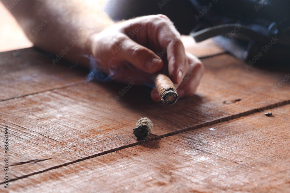 Hand holding and smoking a cigar Stock Photo | Adobe Stock