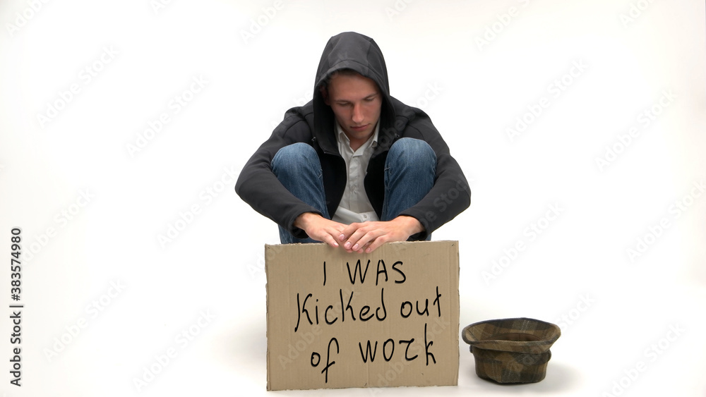 Sad young man was kicked out of work. Depressed guy with cardboard sign ...