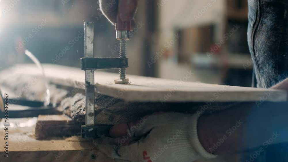 Carpenter in the workshop. Man works with wood materials. Carpenter ...