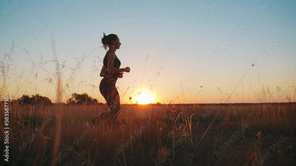Young fitness sport woman running on road at sunset. Athlete runner ...