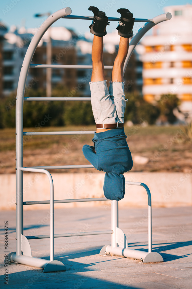 Man hanging upside down on the horizontal bar in anti gravity or ...