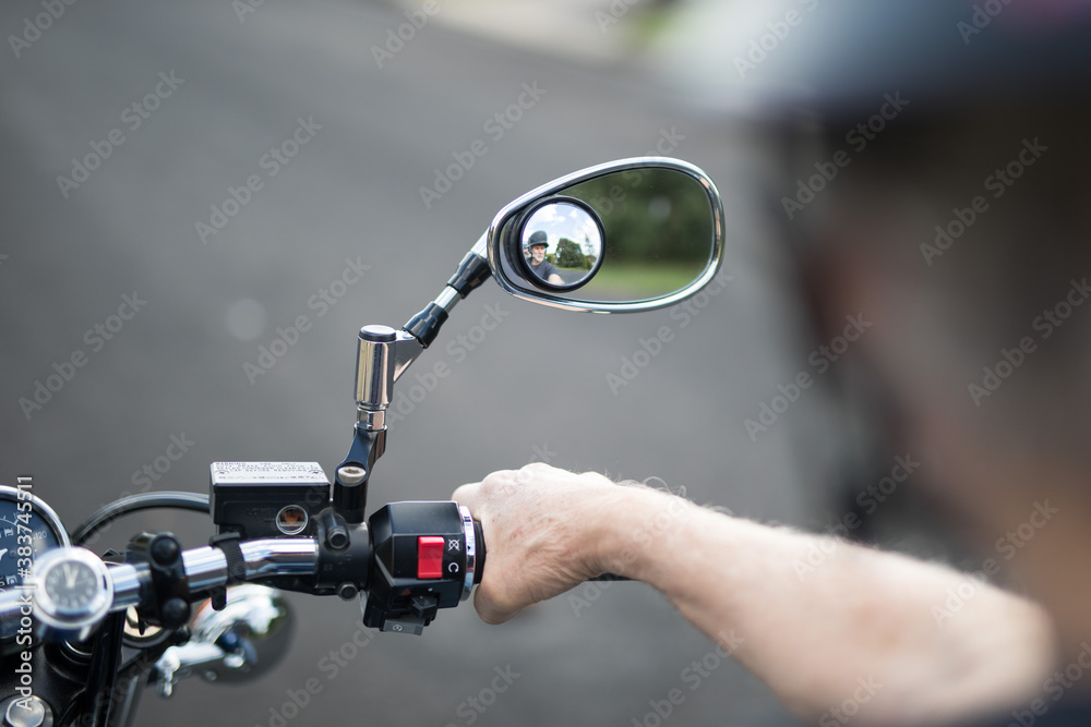 View of a male active senior man riding his bike looking down at the ...