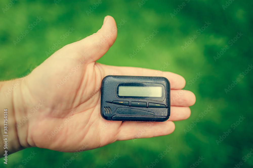 vintage gadget pager. vintage technique. pager in hand on green ...