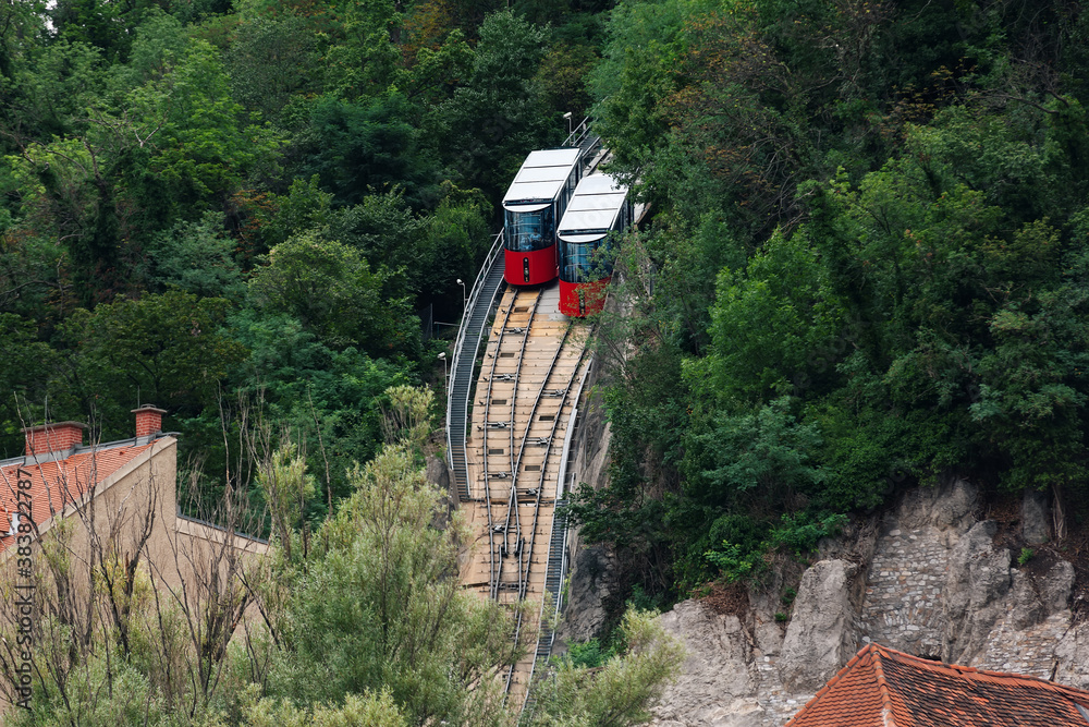 Modern funicular cars moving up and down the tracks. Way to Schlossberg ...