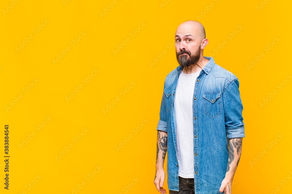 young bald and bearded man with a goofy, crazy, surprised expression ...