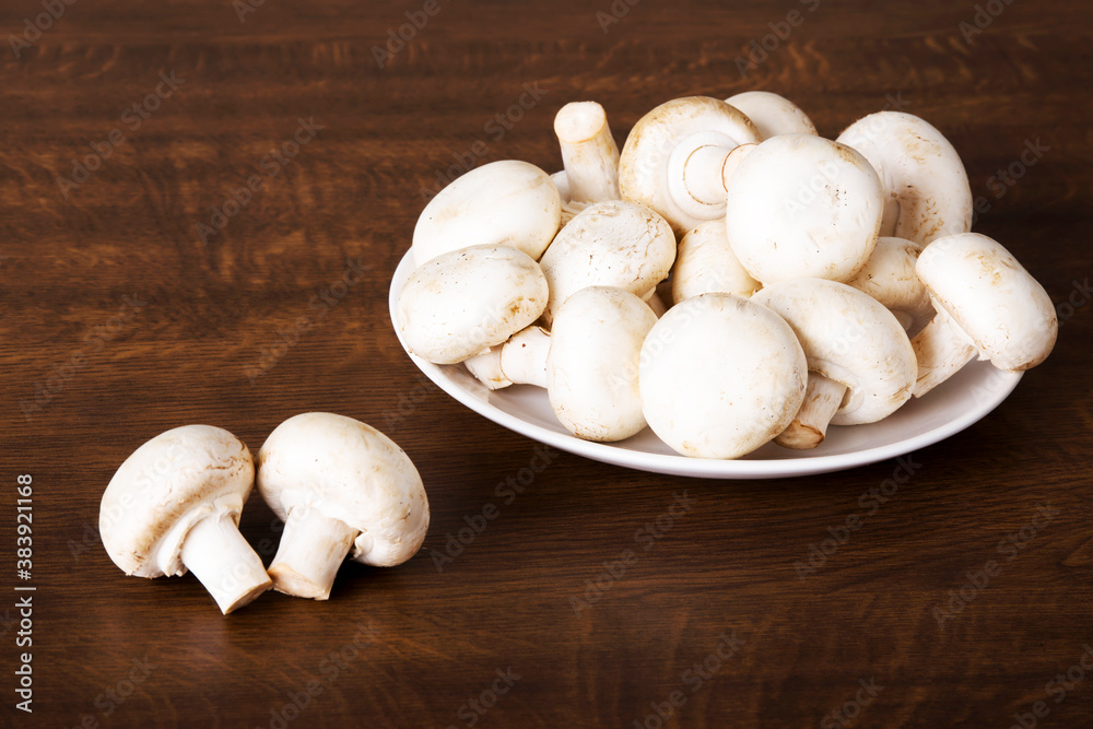 Fresh raw mashroom lying on a plate. Stock Photo | Adobe Stock
