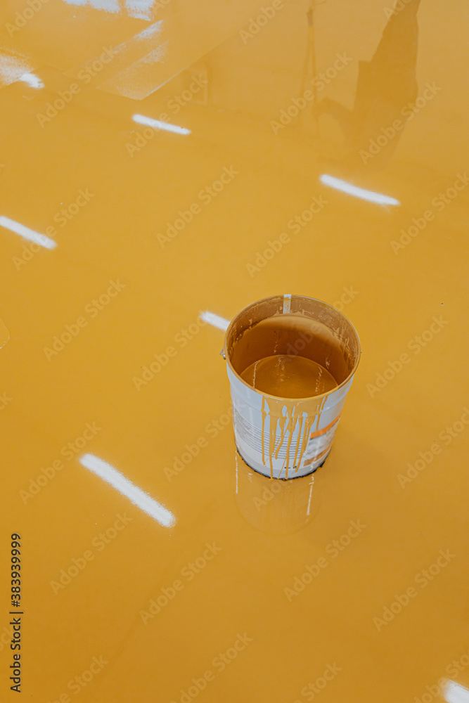 Industrial hall with colored floor, bucket.Epoxy resin applied to the ...