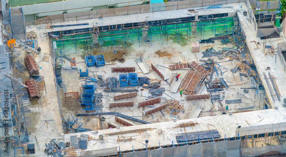 Aerial view of busy industrial under construction site workers working ...