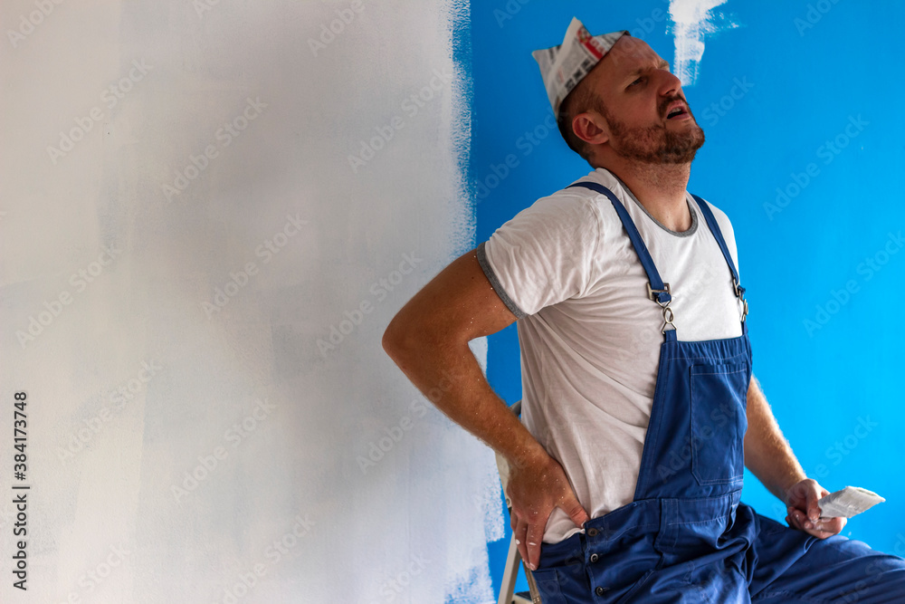 Photo of a man worker with back injury. Close up of young man having ...