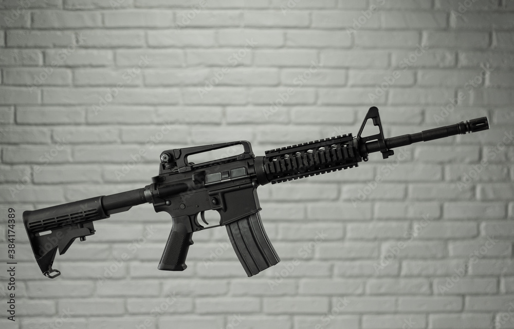 American army rifle M4A1 against a brick wall Stock Photo | Adobe Stock