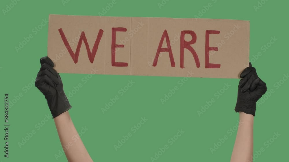 WE ARE. Protest text message on cardboard. Stop racism. Police violence ...