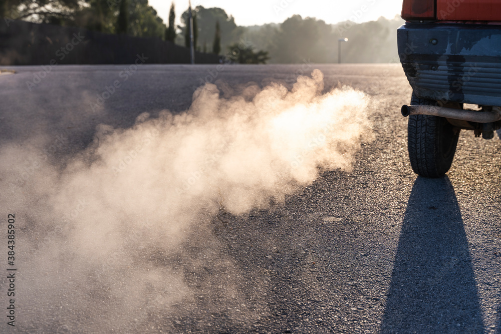 Air pollution from vehicle exhaust pipe on road. Pollution of ...