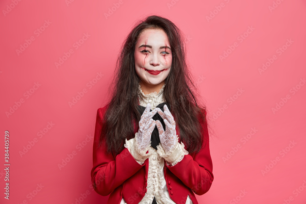 Happy vampire woman has devil plan and intention to do something wears ...