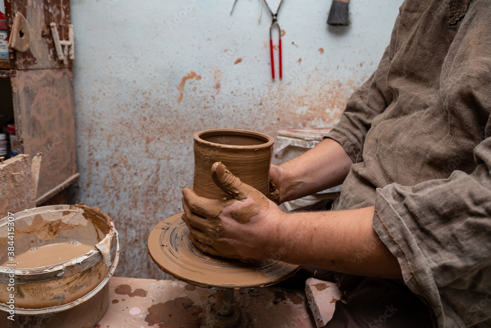 Creating a pot of clay close-up. Hands making products from clay ...