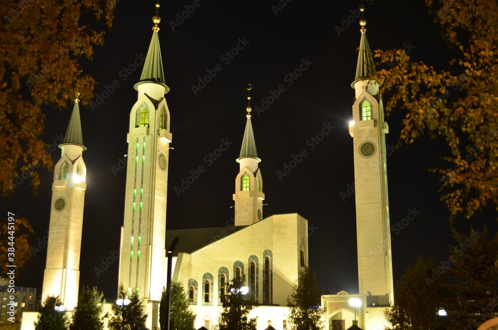 Muslim mosque in the night city. The mosque is illuminated. City mosque ...