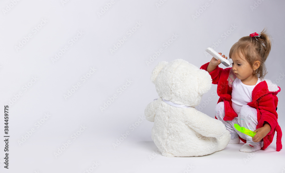 Healthcare concept. Babygirl with bear plush toy. Little girl measures ...