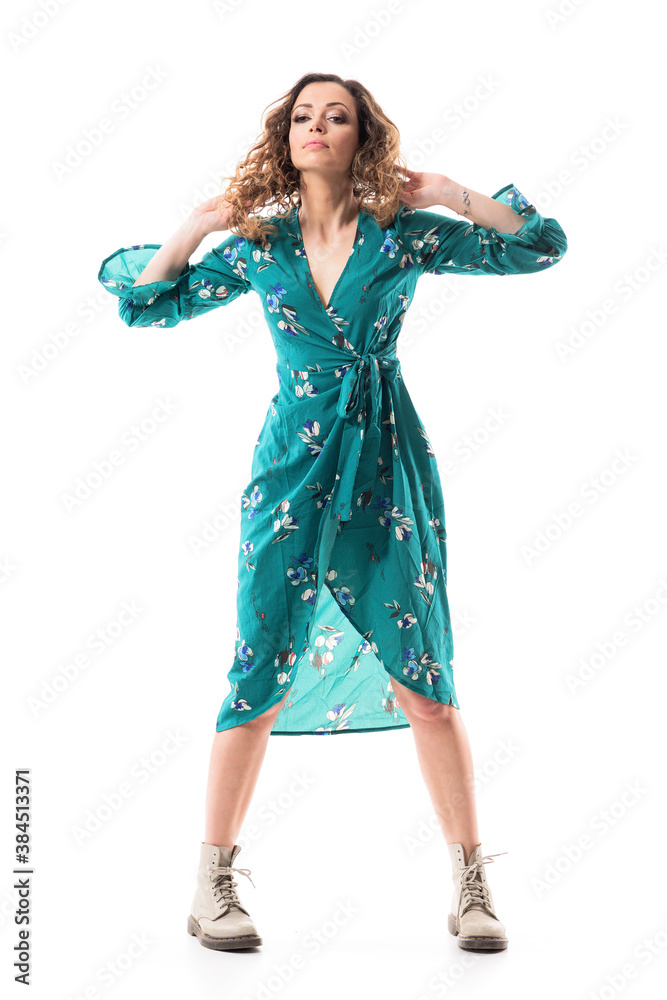 Confident young woman fashion model posing and tossing hair with ...