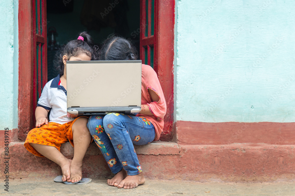 Indian village girls operating laptop computer system seating at home ...