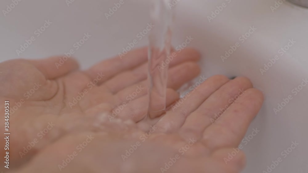Slow Motion. Closeup of Human Hand Under Stream of Pure Water From Tap ...
