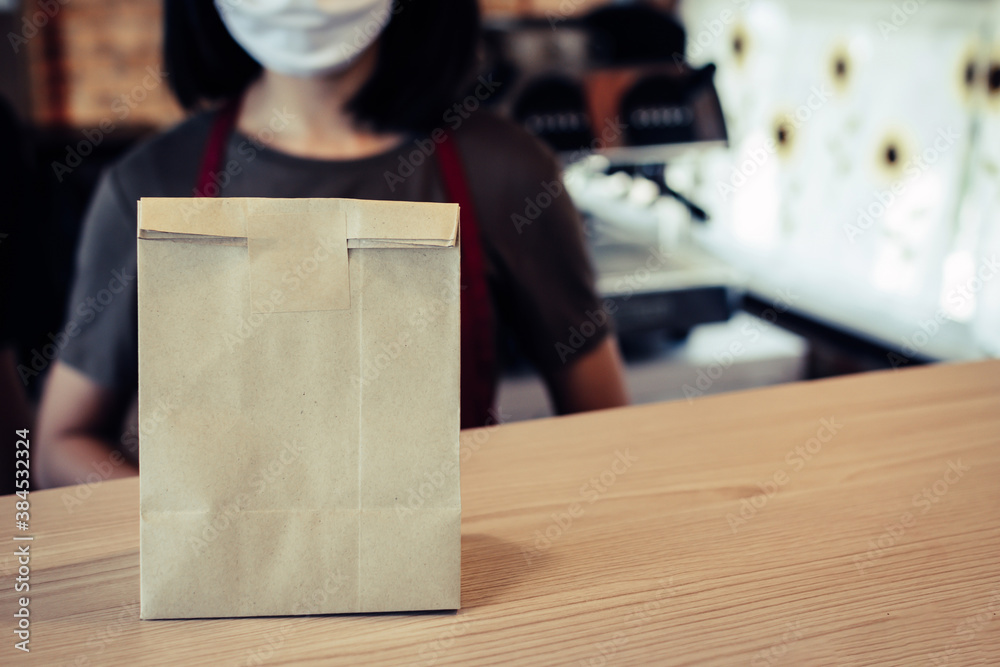 waitress wearing protection face with dessert paper set bag on counter ...