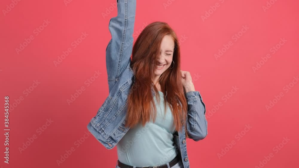 Excited cheerful female model with joyful expression, cheers and ...