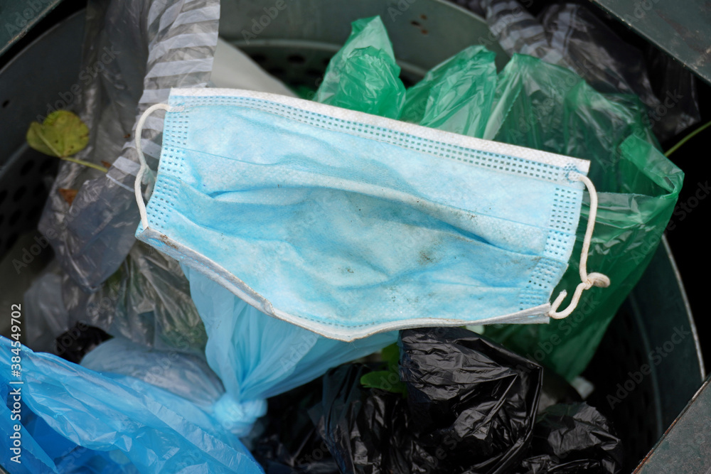 4K, Medical face mask on the floor in the street. Improperly discarding ...