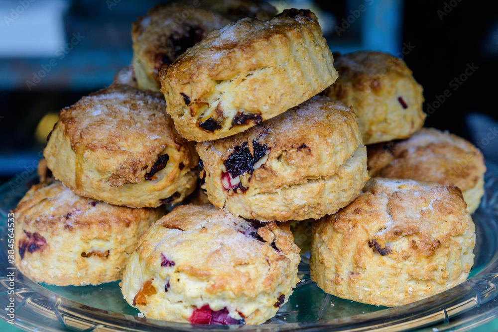 Freshly baked homemade English scones with dried fruits, displayed as a ...